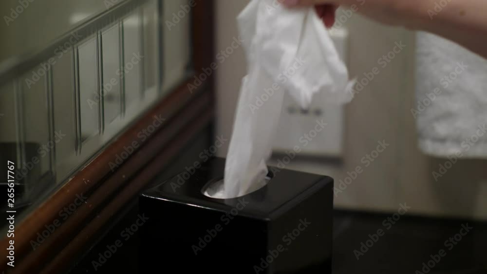 Woman take one paper tissue then one more from black box, closeup shot ...