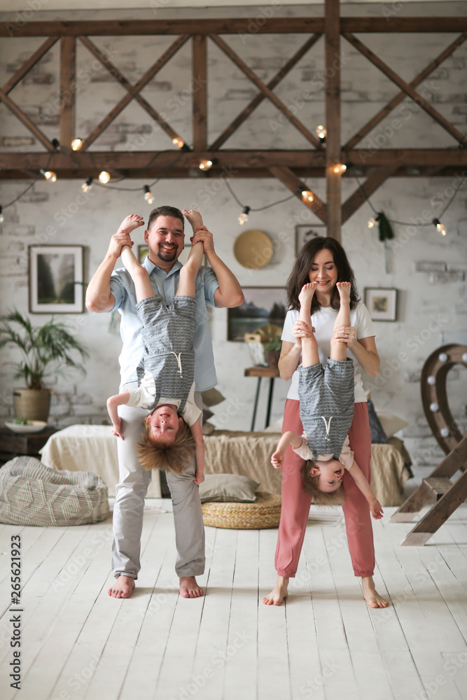 Mom and dad hold children by feet upside down Stock Photo | Adobe Stock
