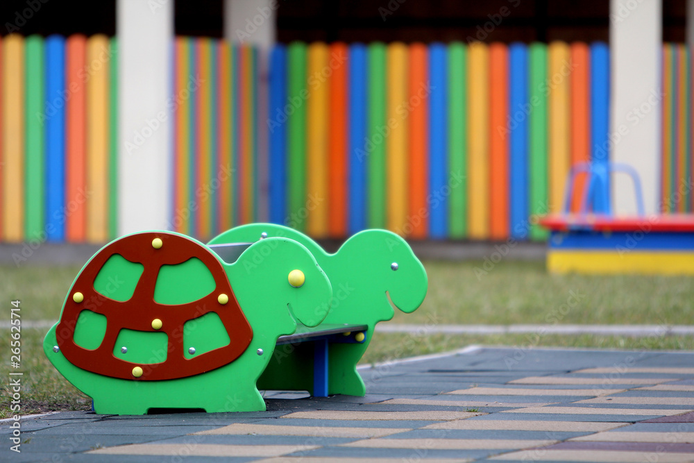 Bright colorful funny bench on nursery playground with soft rubber ...