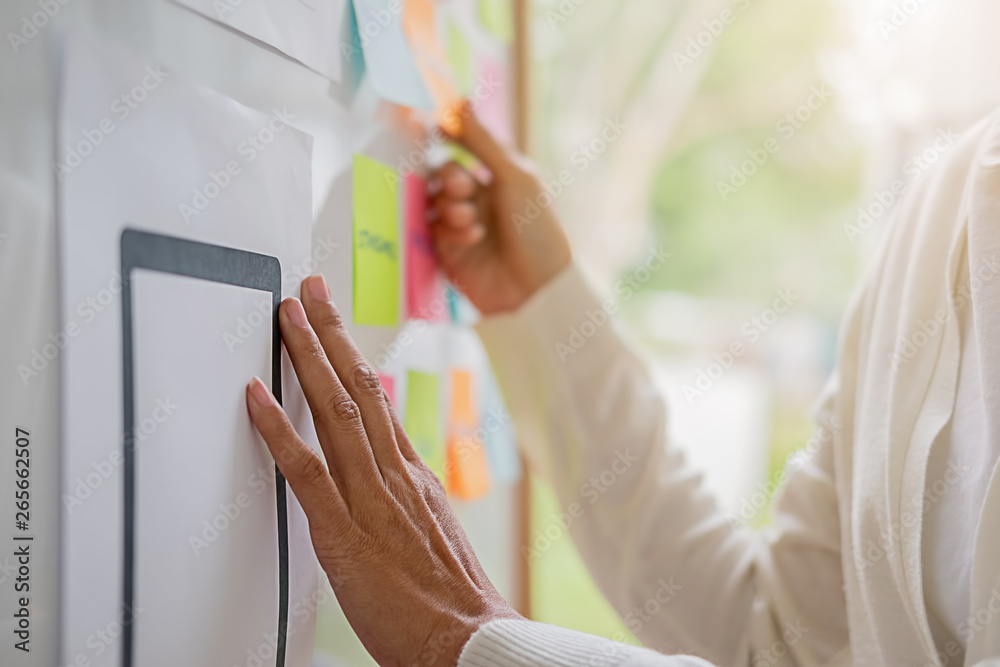 Web designer brainstorming for a strategy plan. Colorful sticky notes ...