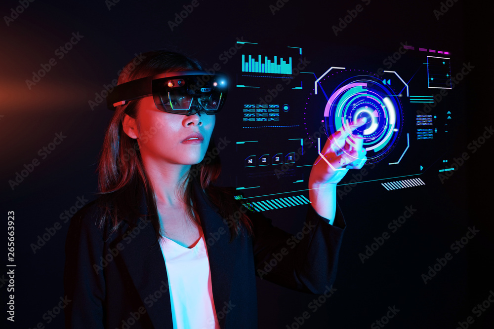 Business woman try vr glasses hololens in the dark room. Portrait of ...