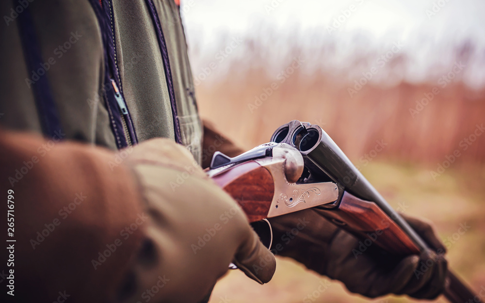 Hunter with a rifle in hunting Stock Photo | Adobe Stock