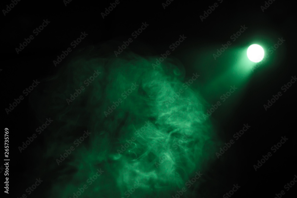 projector spotlight green color , smoke texture background . light beam ...