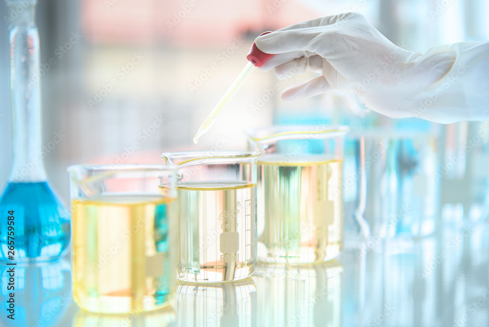 scientist in laboratory with test tubes, Test tubes with liquid in ...