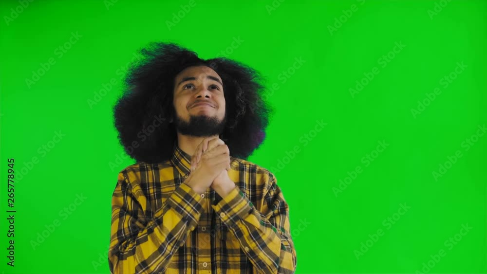 Vidéo Stock Portrait of praying african american guy keeping fingers ...