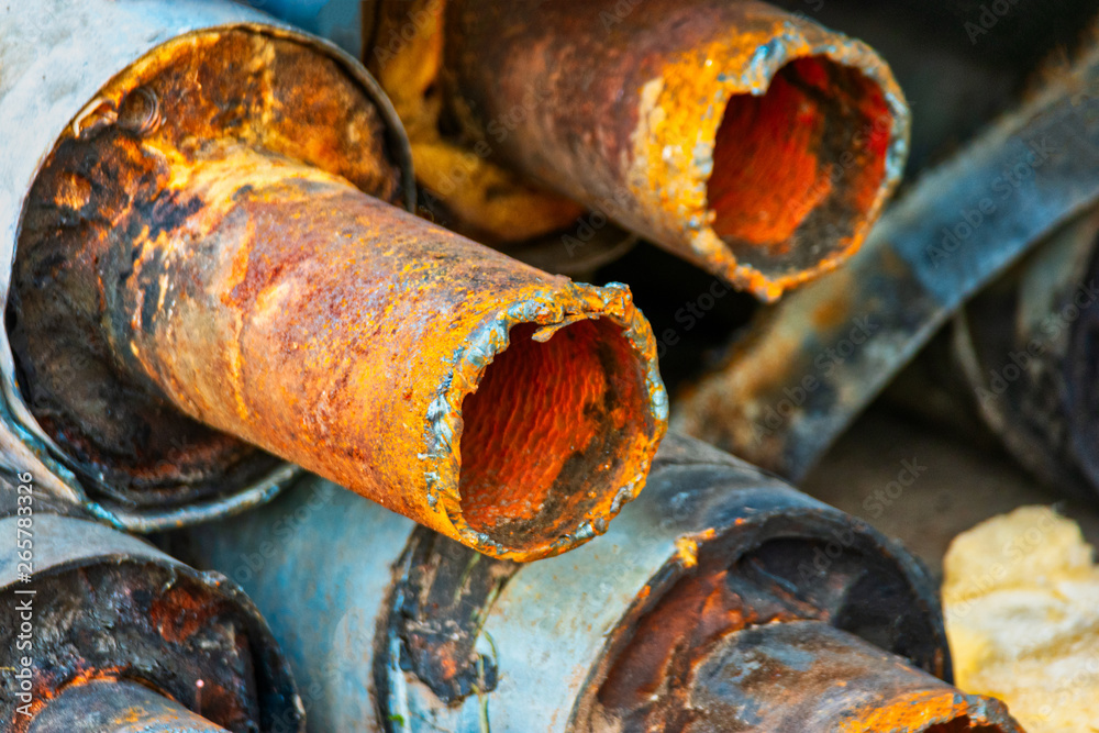 Closeup of Stack of corroded steel pipes with worn insulation ...