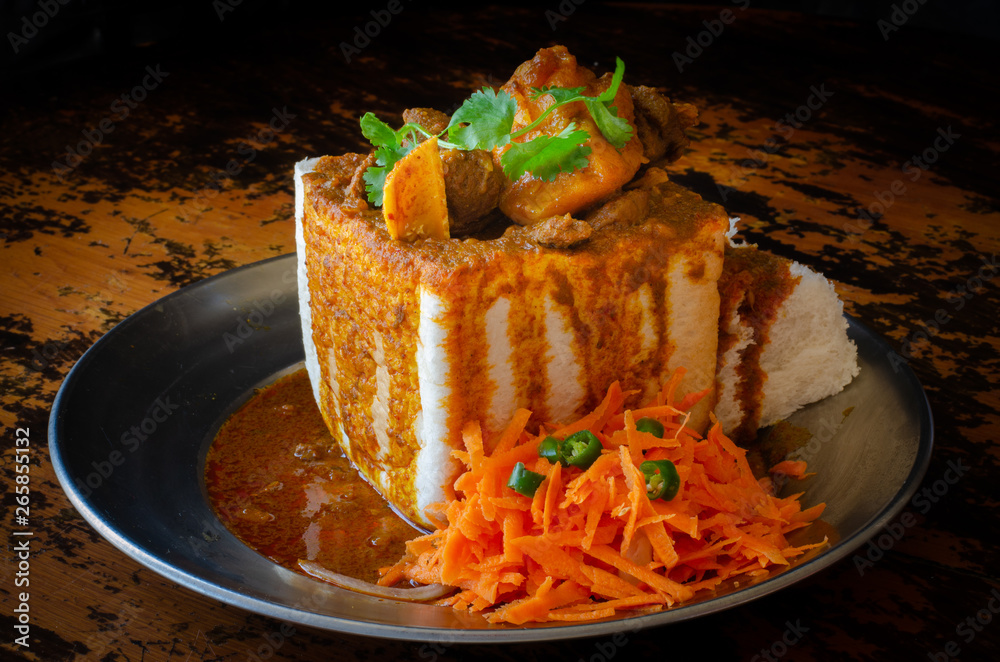 A Durban Bunny Chow - or quarter mutton bunny - served with sambals ...