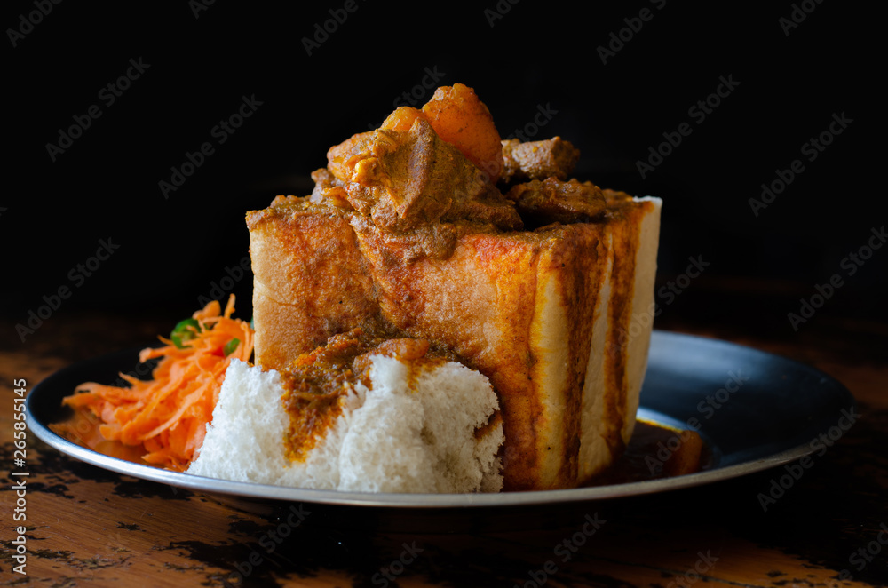 A Durban Bunny Chow - or quarter mutton bunny - served with sambals ...