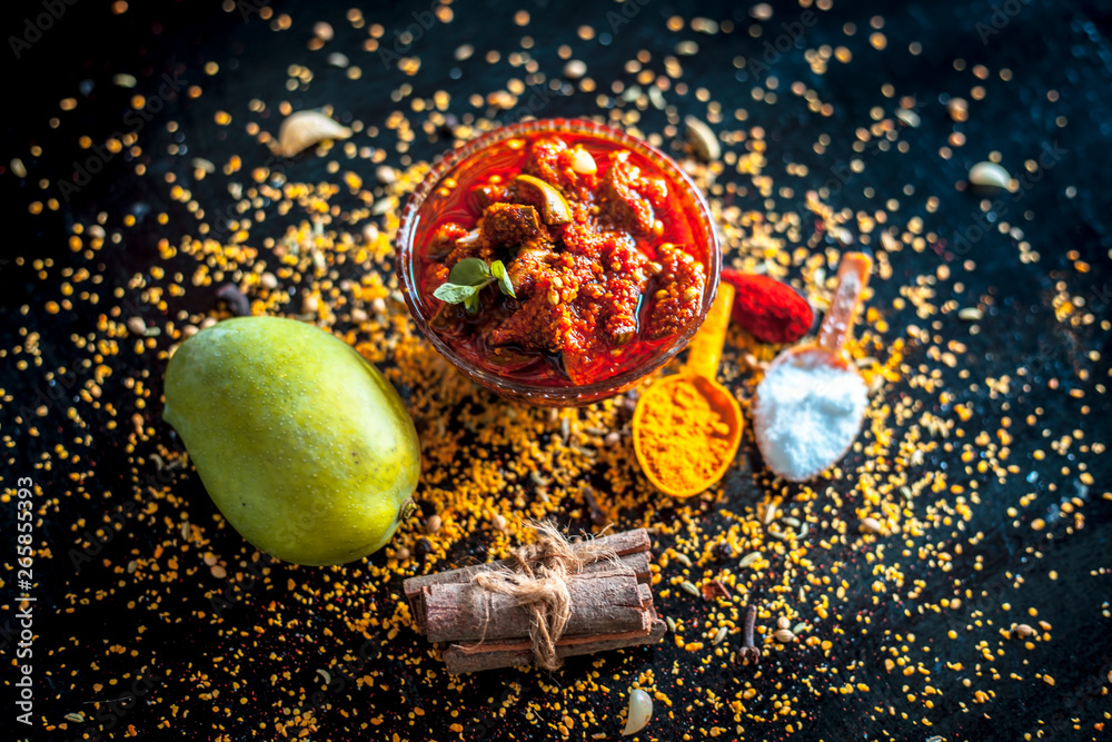 Popular Indian & Asian pickle of mango in a glass bowl i.e. Aam ka achar in a glass bowl or keri ...
