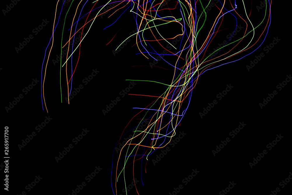 Abstract colorful lines on black background. Light painting photography ...