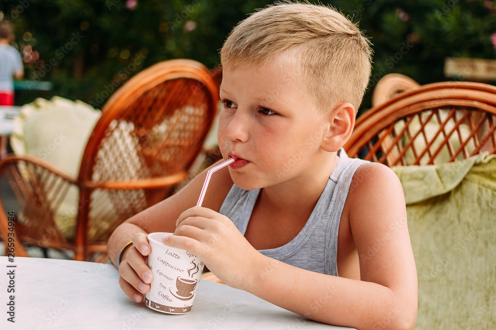boy drinking juice from tubules Stock Photo | Adobe Stock