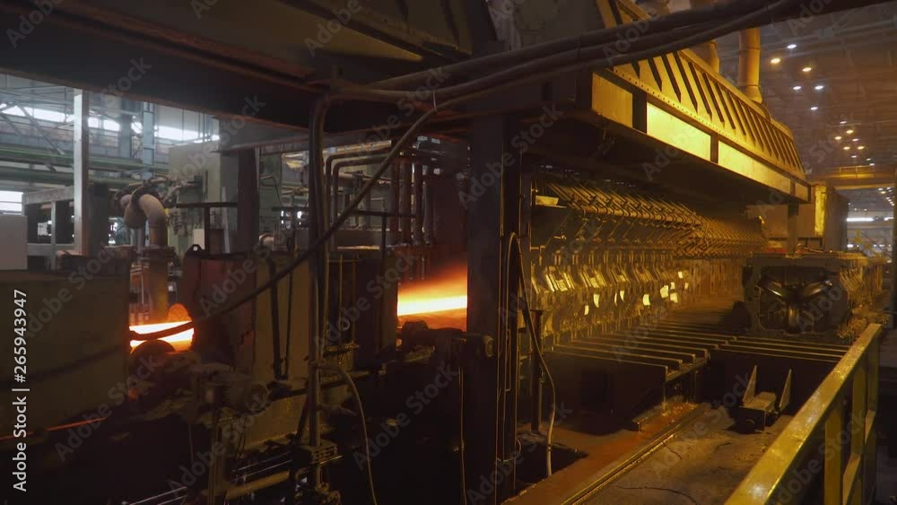 Steel mill, steel pipes production, red-hot pipes transported on ...