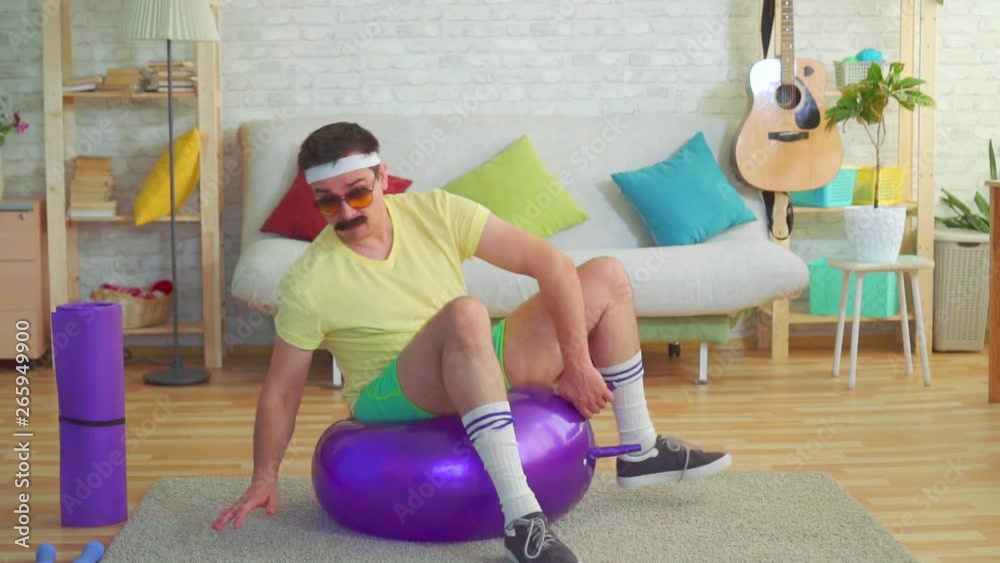 Funny young man with a mustache from the 80s trains and absurdly falls ...