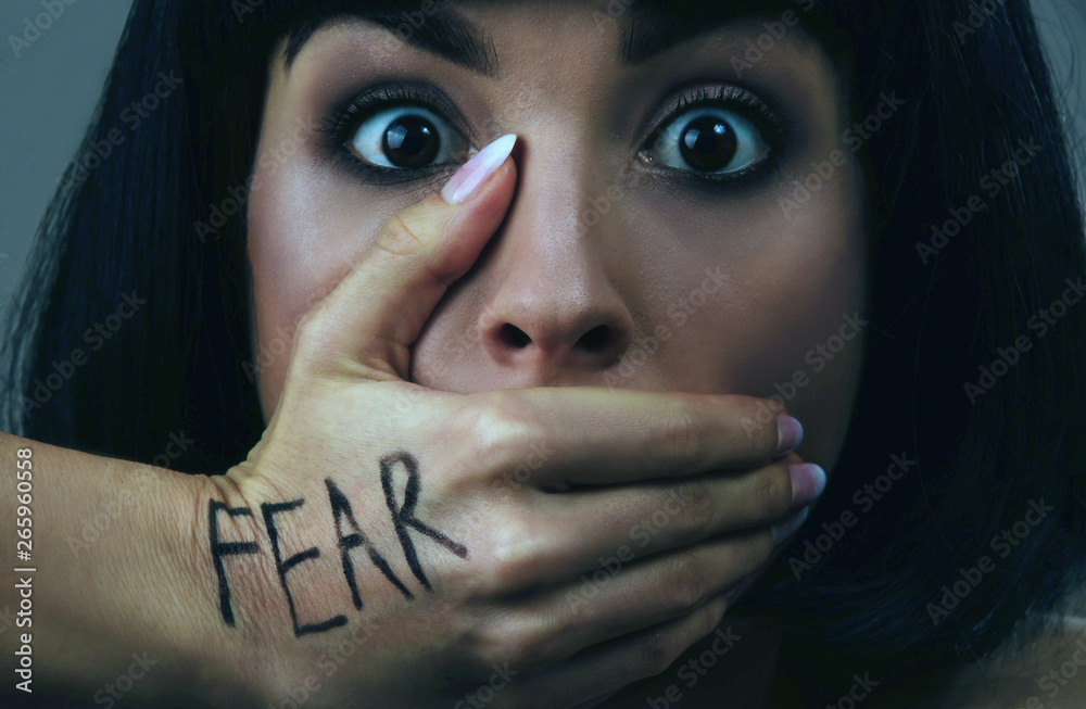 Young scared woman with black hair posing on camera. Scared brunette ...