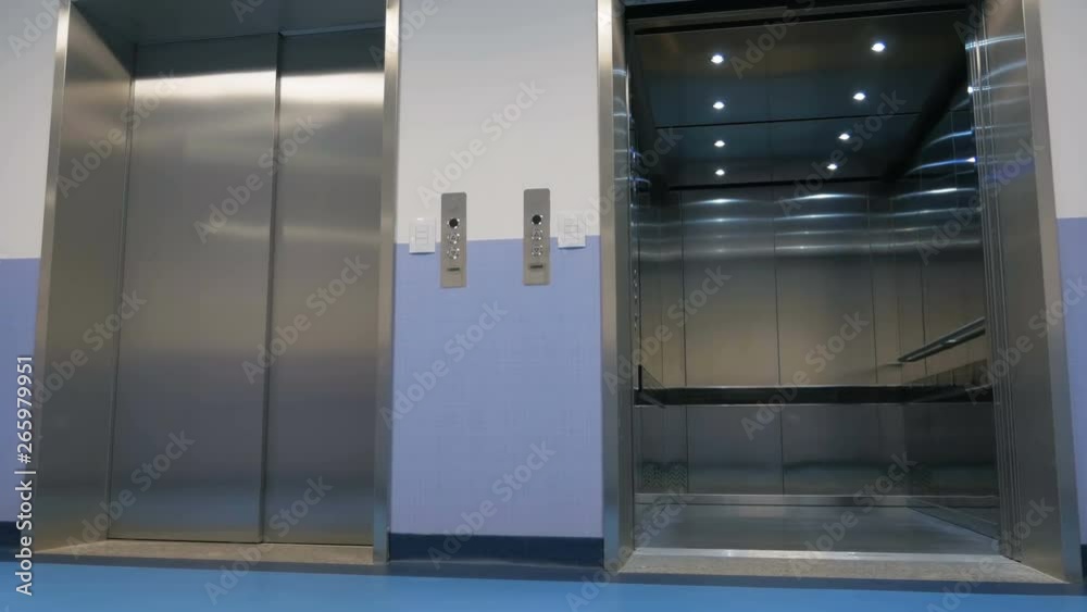 Opening and closing doors of elevator in a large office building ...