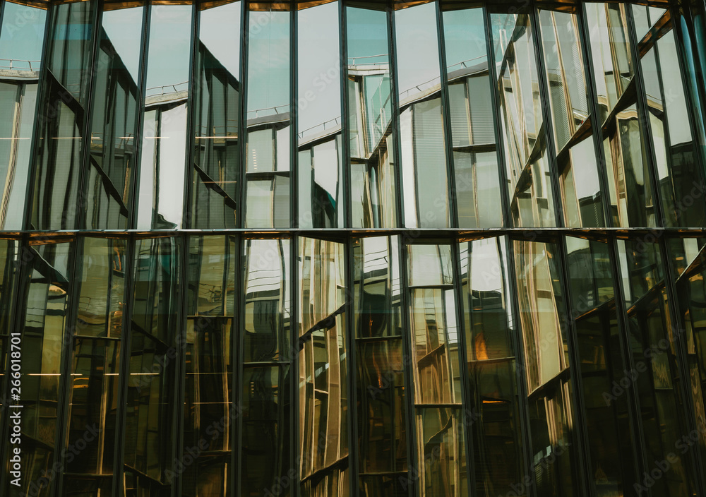 Glass window of a building with black aluminum frames, blue tone as ...