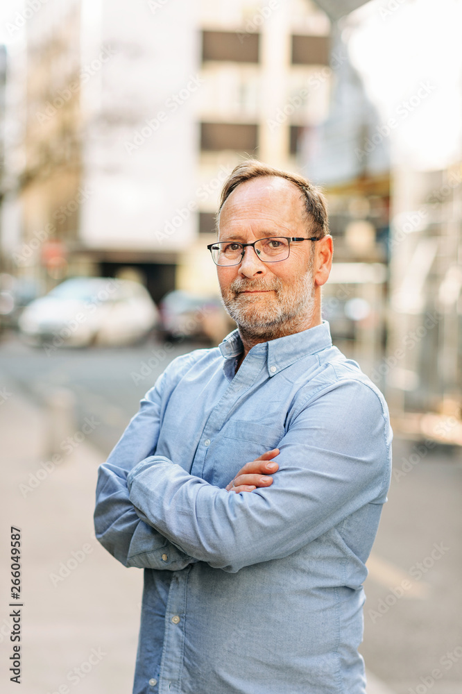 Outdoor portrait of handsome middle age man wearing long sleeve Oxford ...