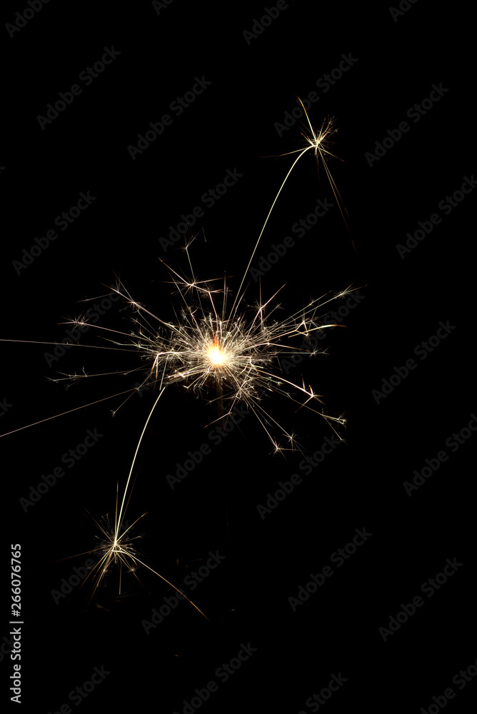 Burning squib on a black background with sparks. Stock Photo | Adobe Stock