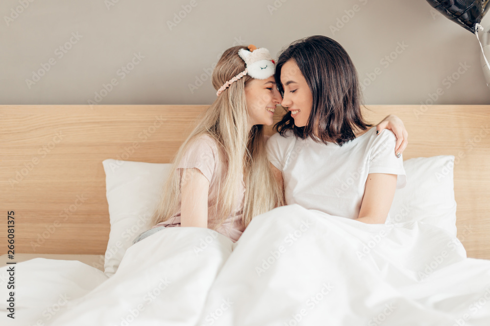 two positive attactive girls are gossiping with each other. close up ...