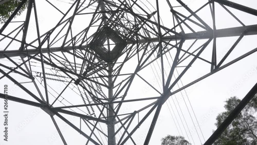 Vidéo Stock Abstract rotation under tall power pylon tower. Electric ...