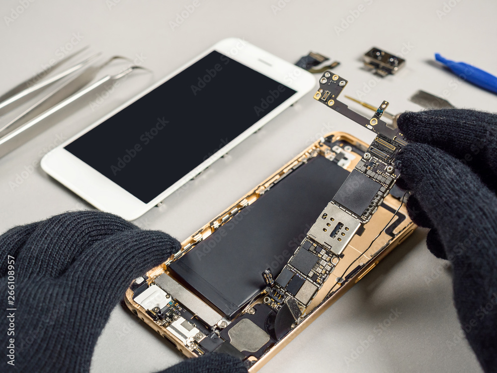 Technician or engineer disassembling components broken smartphone and ...