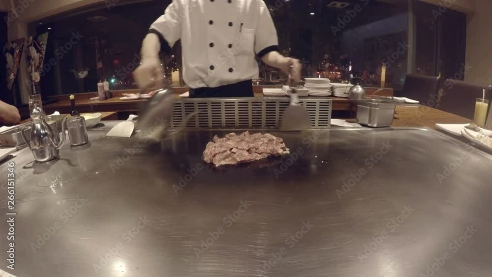 Japanese chef prepares beef teppanyaki on hibachi. Seafood prawns and ...