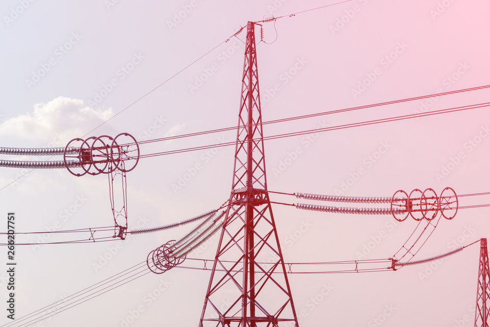 metal poles of a power line with wires against a blue sky. Sunset ...