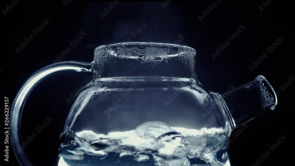 Close-up of boiling water in a glass teapot, transparent teapot on a ...