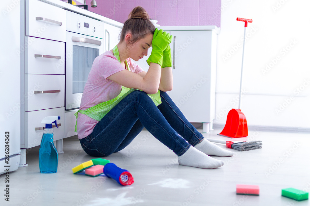 Young overworked housewife is tired of household chores and spring ...