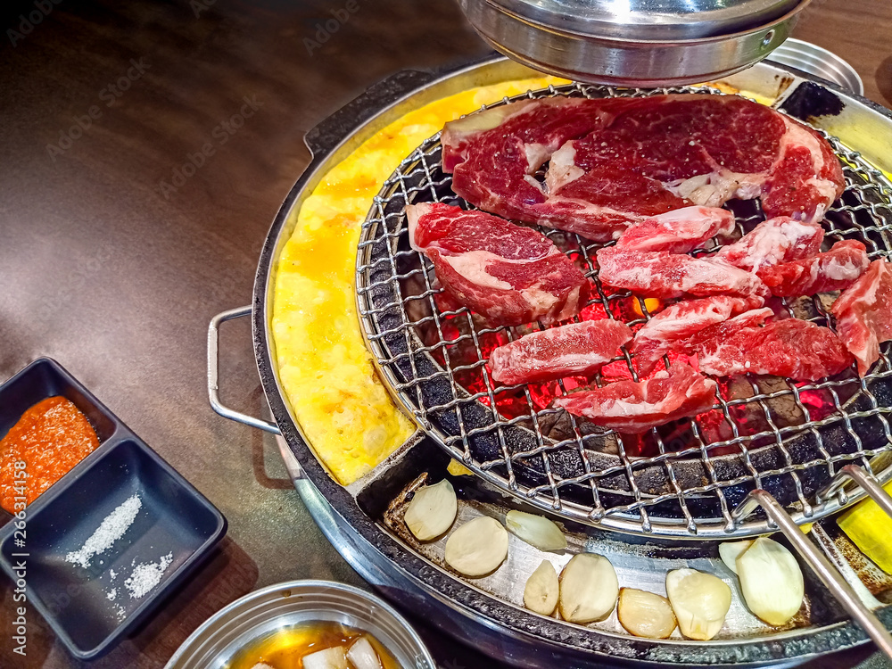 Roast beef Sizzling Korean BBQ on mesh grill of charcoal fire ( Bulgogi ...