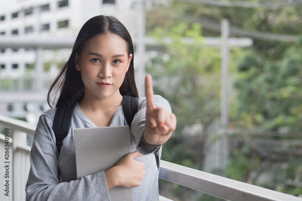portrait of happy smiling asian woman college student pointing up 1 ...