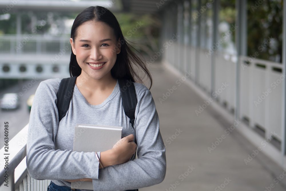 portrait of happy smiling asian woman college student in city campus ...