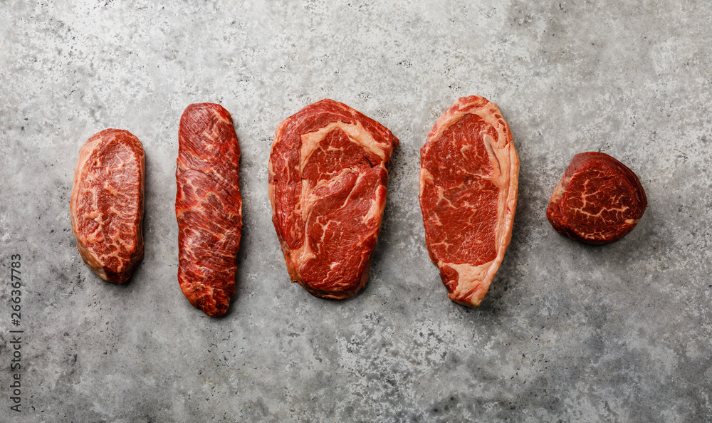 Variety of Raw Black Angus Prime meat steaks Top Blade, Denver, Rib Eye ...