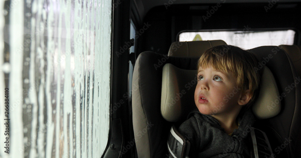 Little boy looking through misted window. Cleaning Car Using High ...