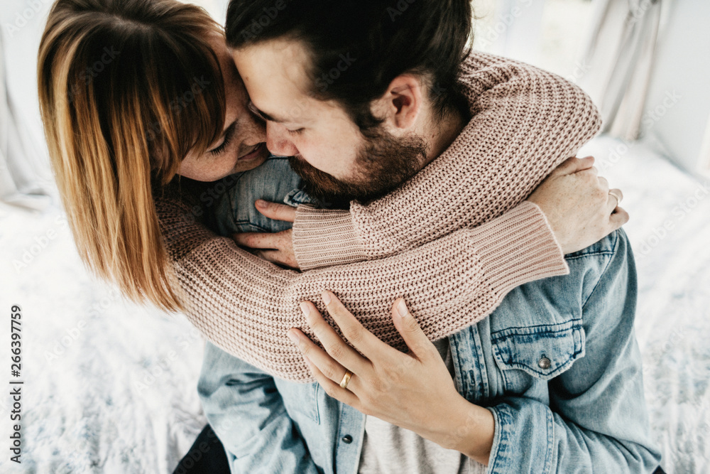 Cute hipster couple cuddling in converted school bus tiny home Stock ...