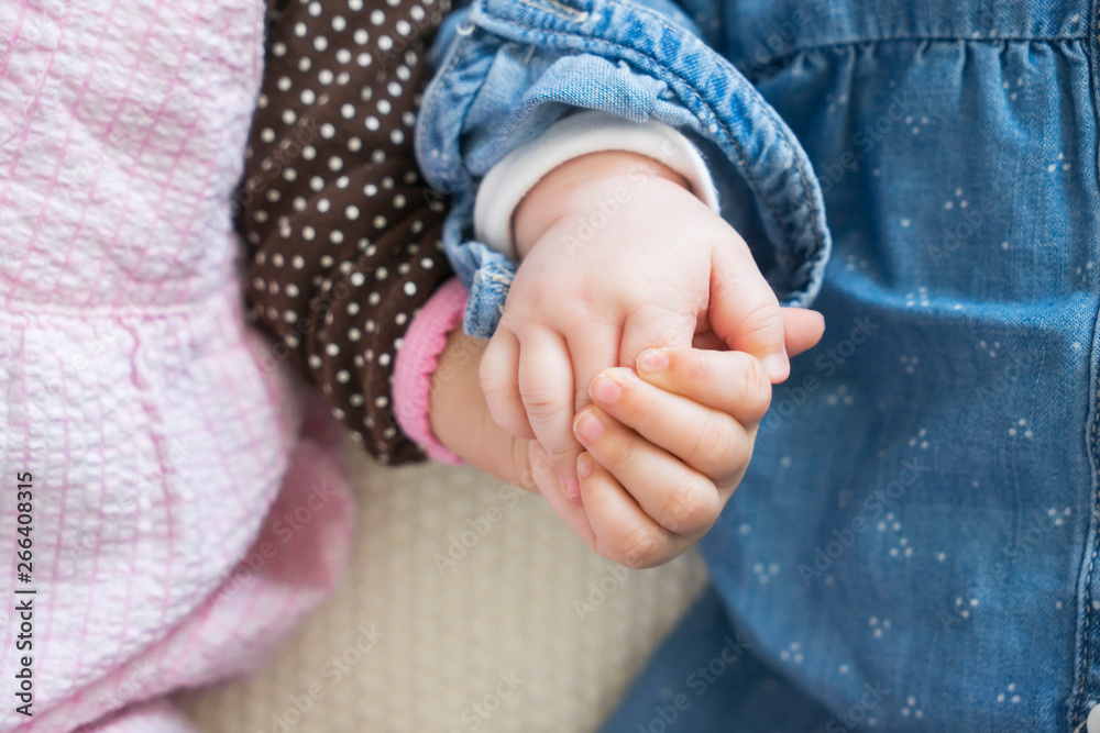 Early friendship - baby holding their hands Stock Photo | Adobe Stock
