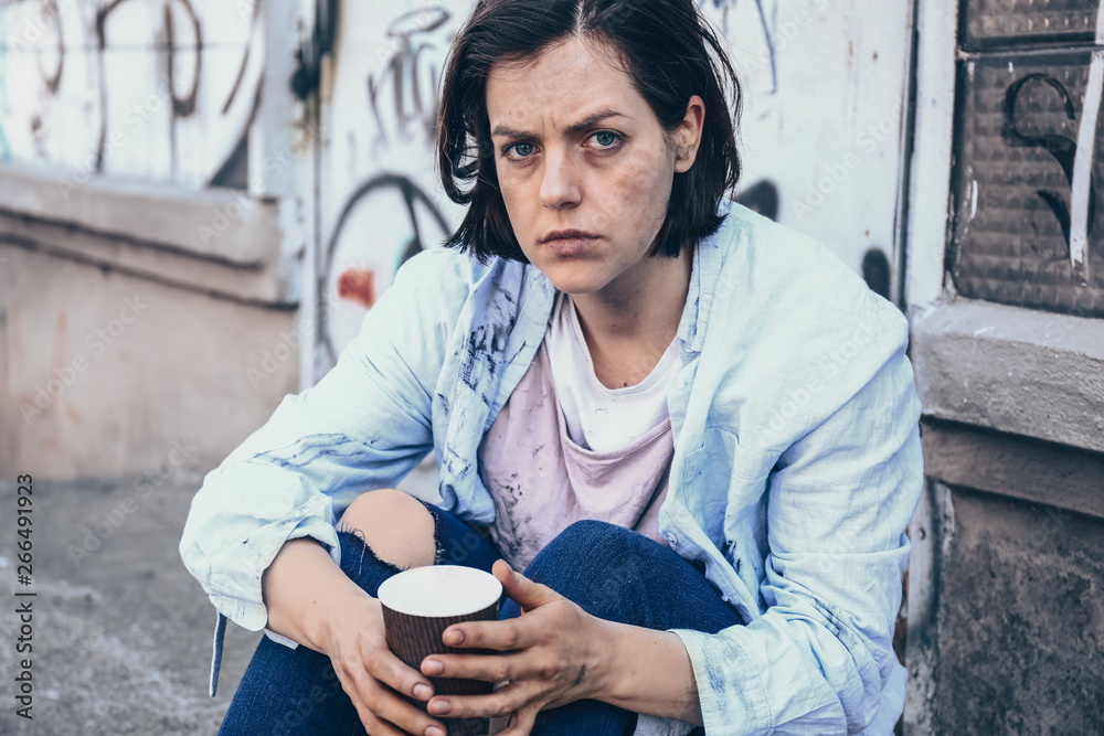 Poor homeless woman begging for help outdoors Stock Photo | Adobe Stock