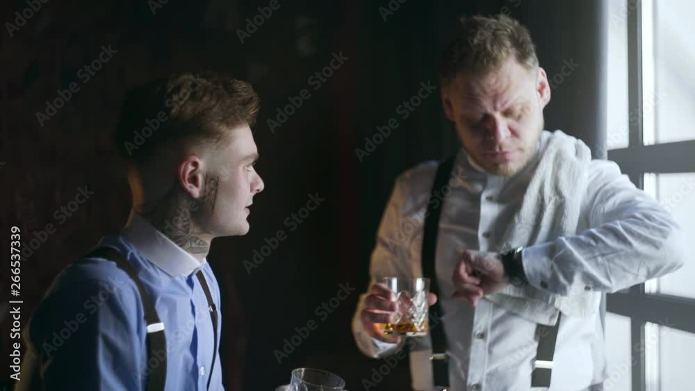 Two adult tattoed friends drinks whiskey and have a talk, 30's mafia ...