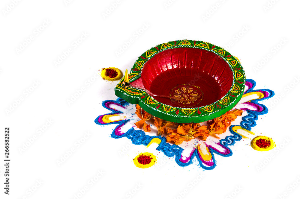 Rangoli and Single Clay diya lamp lit during diwali festival. Happy ...