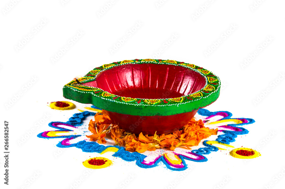 Rangoli and Single Clay diya lamp lit during diwali festival. Happy ...