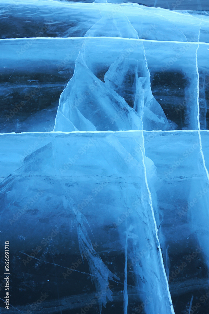 Sun rays are refracted by the transparent ice of Lake Baikal. cracks at ...