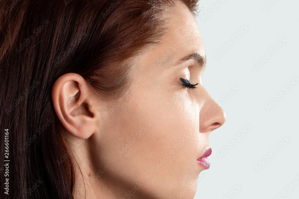 Beautiful, young girl Detail of the head with the female human ear and ...