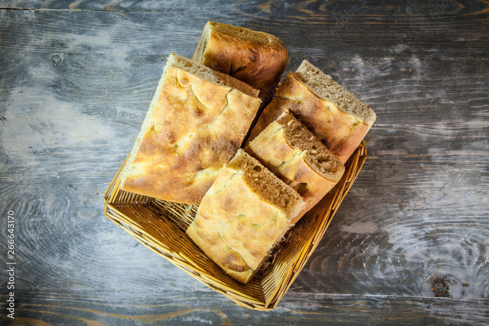 Italian bread of Focaccia Genovese type on a rustic wooden table ...