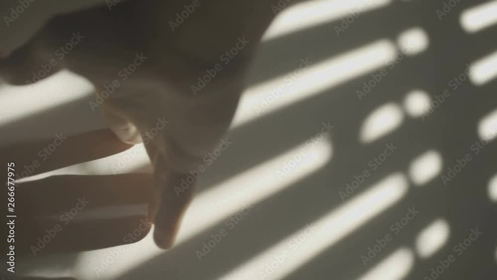 Vidéo Stock Man passes his hand on the white wall with a hard window ...
