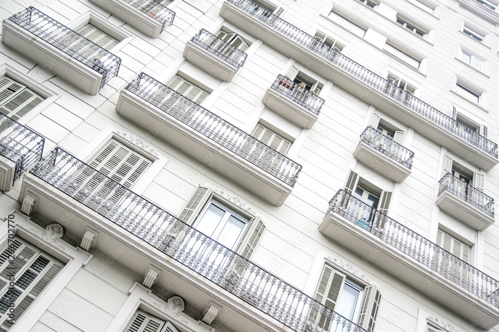 White facade of a tall building in a city. Real State concept with ...
