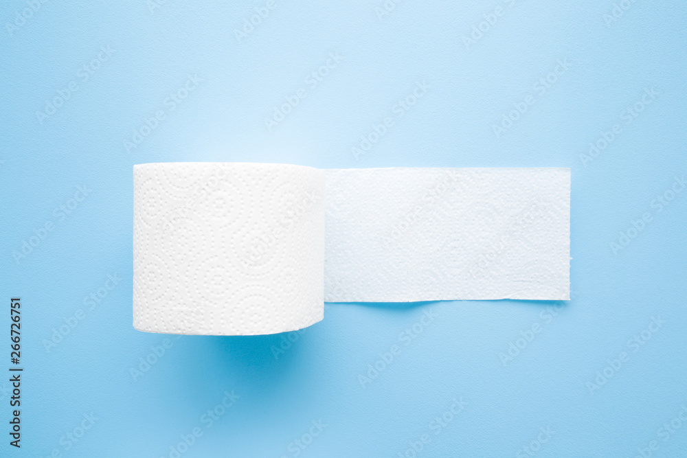 Soft, white toilet paper roll on light pastel blue background. Hygiene ...