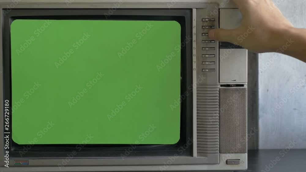 Male hand changing channels on the retro old TV with green screen ...