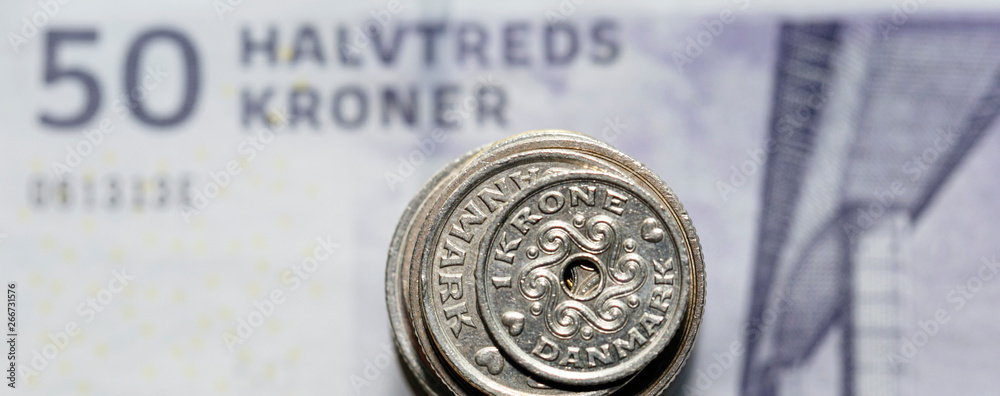 Mixed Danish coins over a Danish fifty Kroner banknote in a web banner ...