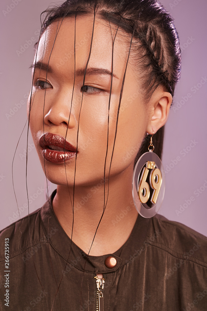 Portrait of an Asian girl with fishtail and wet hair locks on her face ...