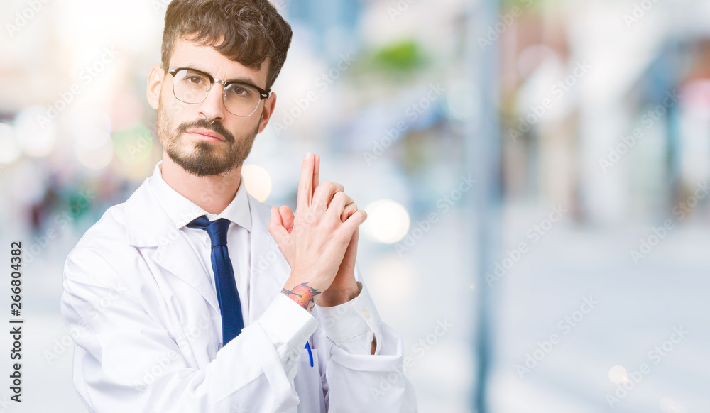 Young professional scientist man wearing white coat over isolated ...